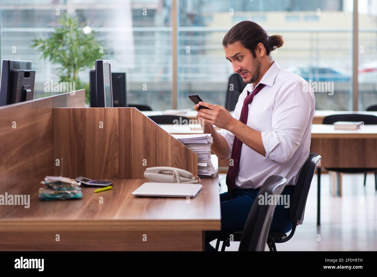 Young employee and too many work in the office Stock Photo - Alamy