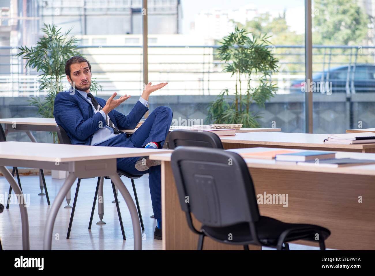 Young teacher in suit in the classroom Stock Photo - Alamy