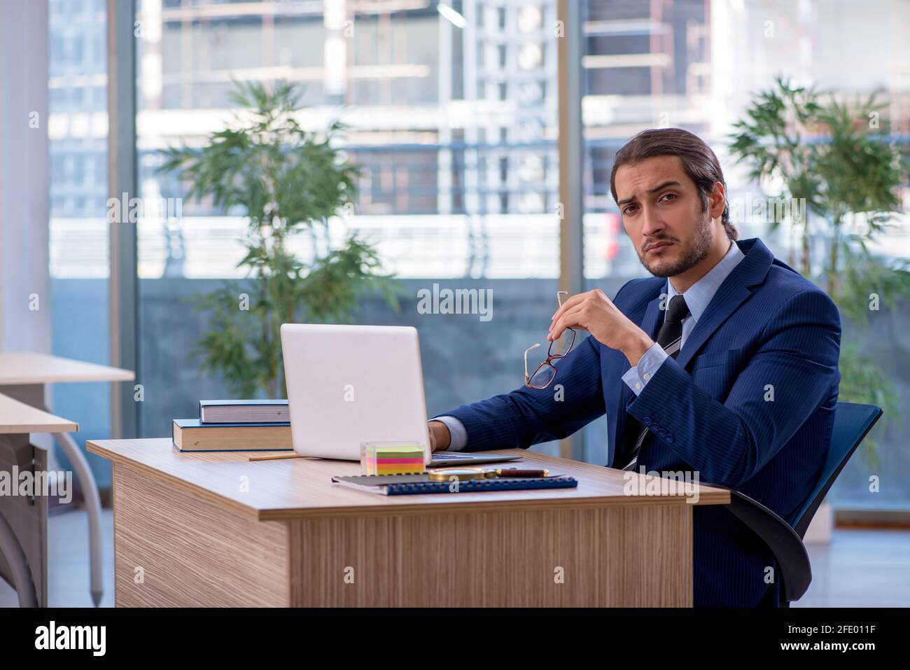 Young teacher in suit in the classroom Stock Photo - Alamy