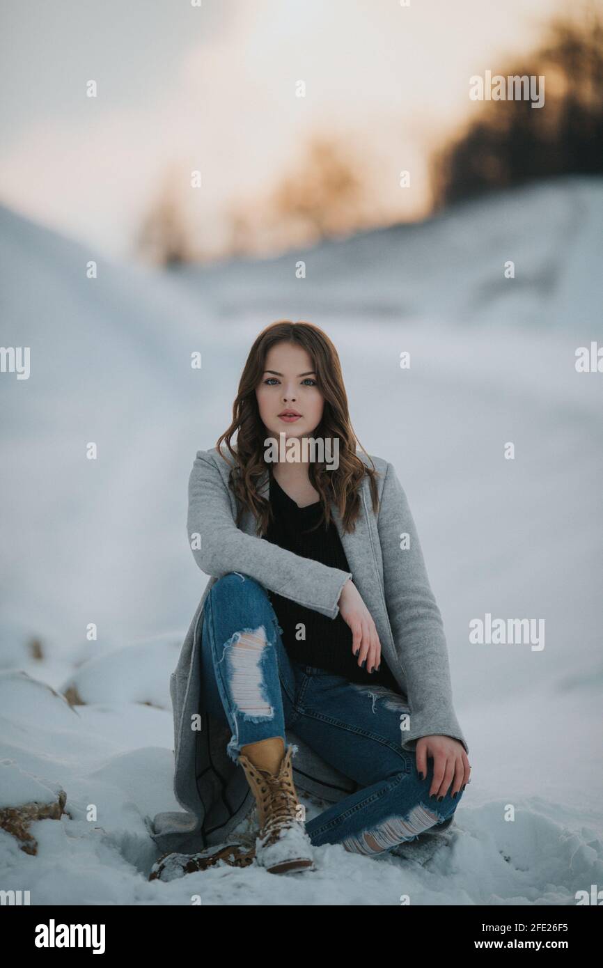 Young beautiful Bosnian woman in a jacket posing outdoors in the winter ...