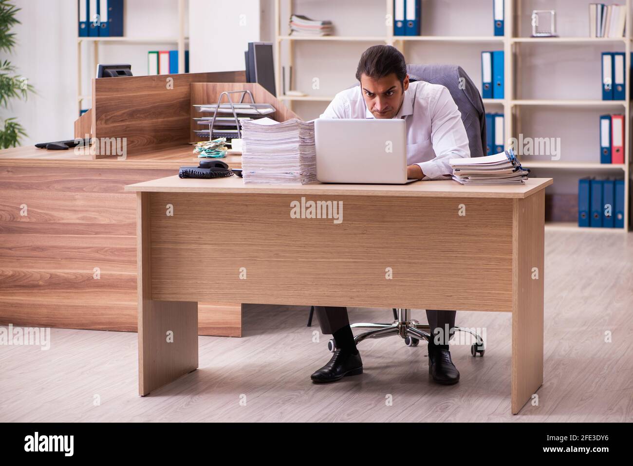 Young employee extremely tired with excessive work Stock Photo - Alamy