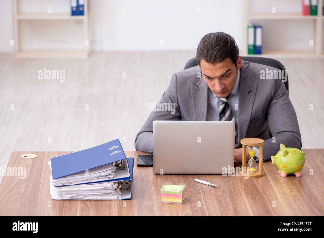 Young employee in pension concept at workplace Stock Photo - Alamy