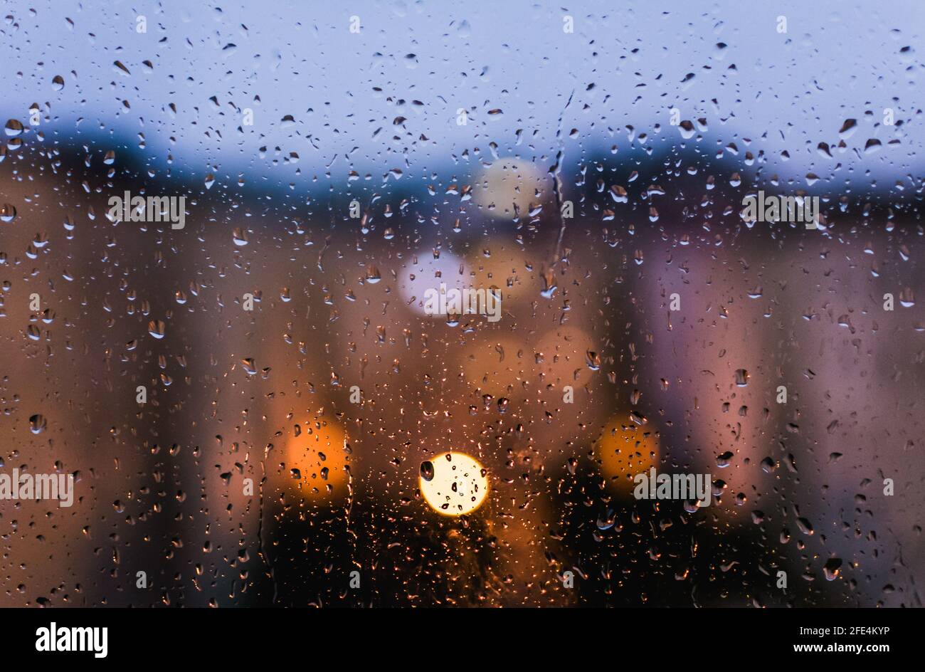 Rain drops in window during dusk. Sadness, depression, rainy. Bokeh of ...