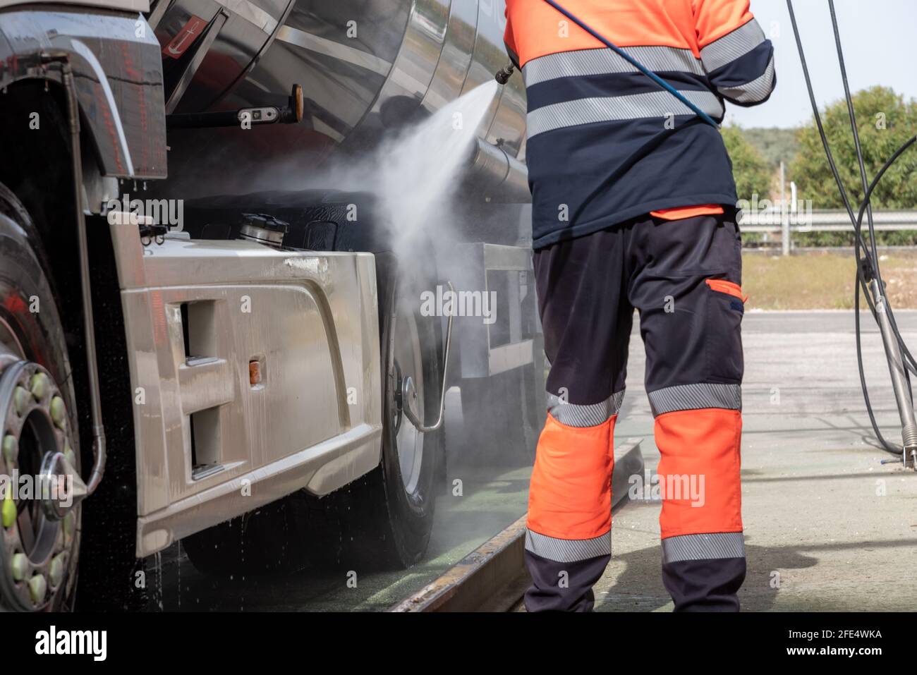 Truck driver cleaning the exterior of the vehicle Stock Photo - Alamy
