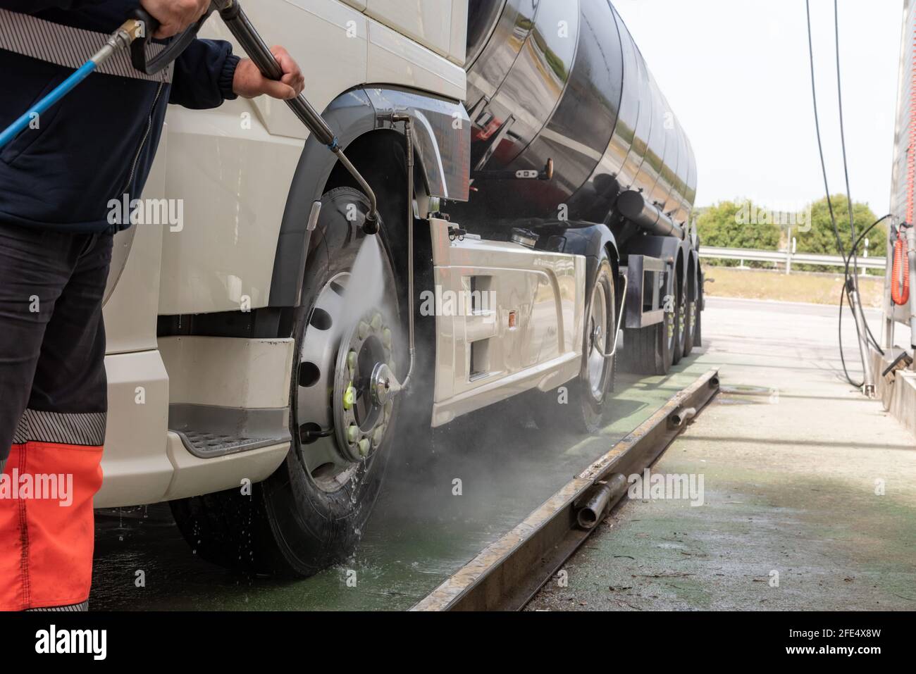 Truck driver cleaning the exterior of the vehicle Stock Photo - Alamy