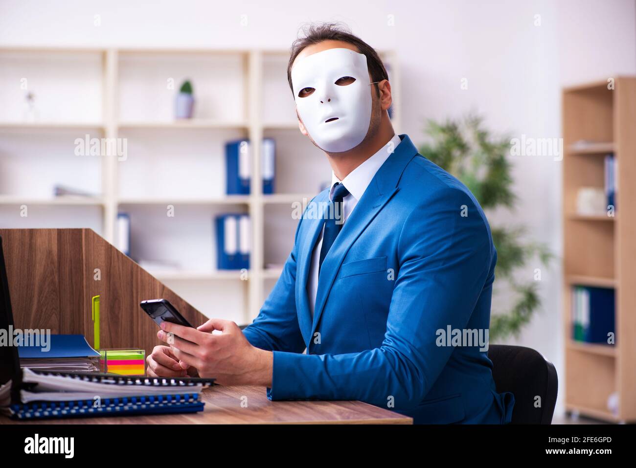 Young employee wearing mask in the office Stock Photo - Alamy