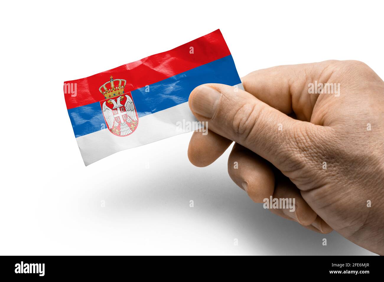 Hand holding a card with a national flag the Serbia Stock Photo - Alamy