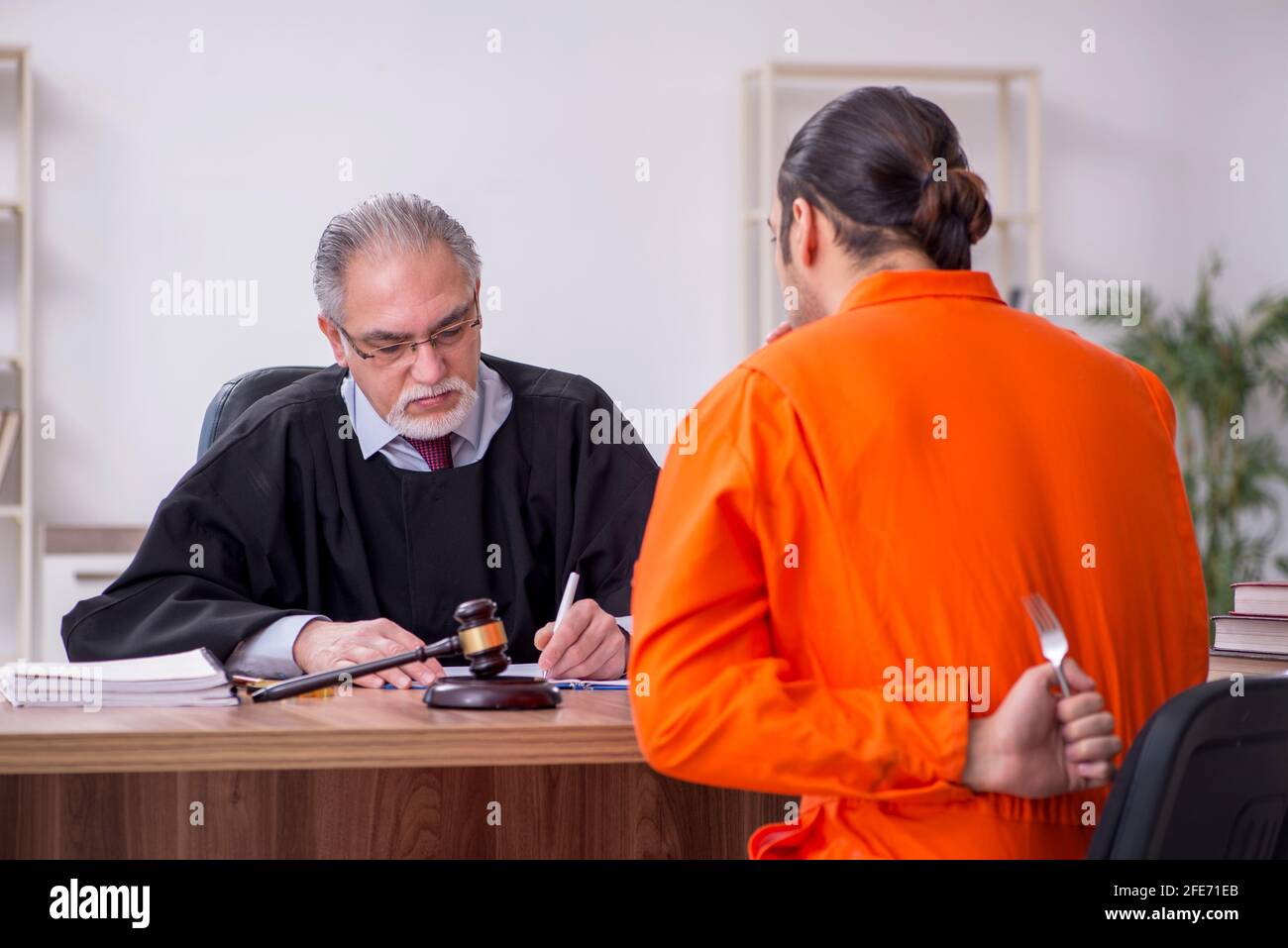 Old judge meeting with young captive in courthouse Stock Photo - Alamy