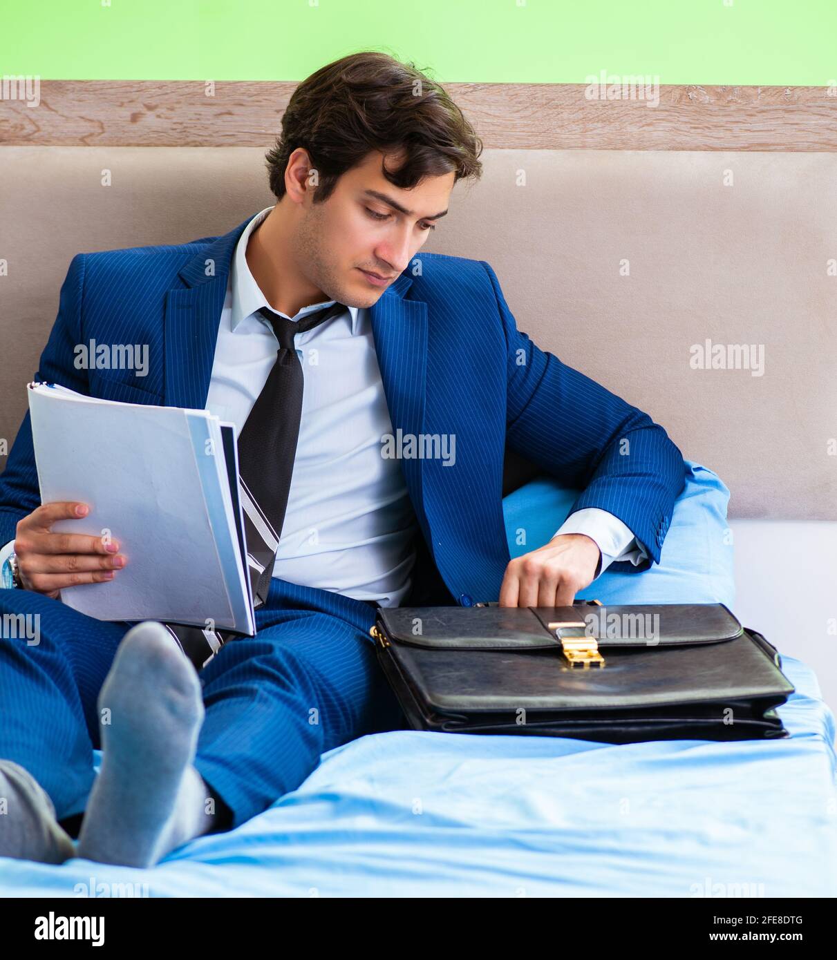 The businessman working in the hotel room Stock Photo - Alamy