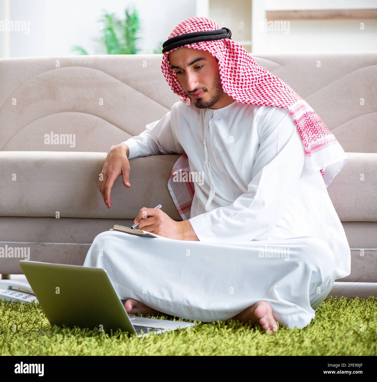 The arab man working at home on his work Stock Photo - Alamy