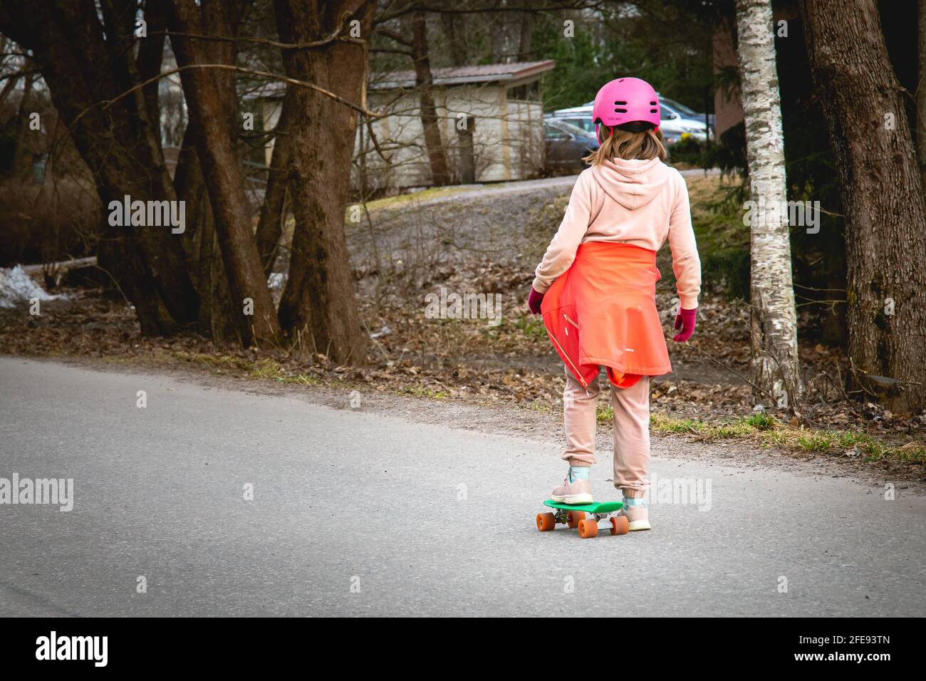 Girl skateboarding on the street wearing a helmet and sportswear Stock ...