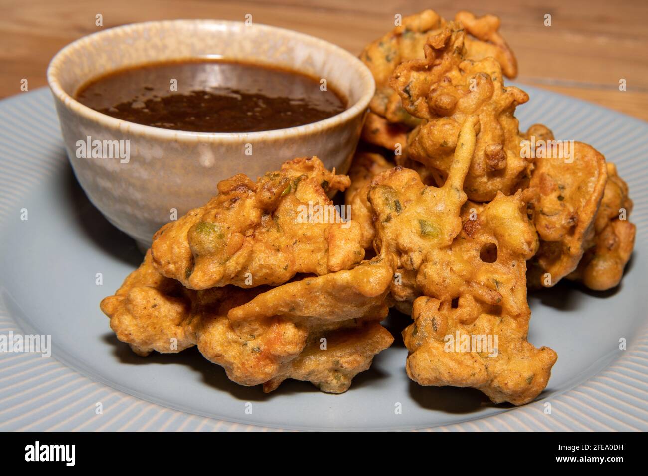 A delicious plate of Indian Pakoras with a spicy nipping sauce on a ...