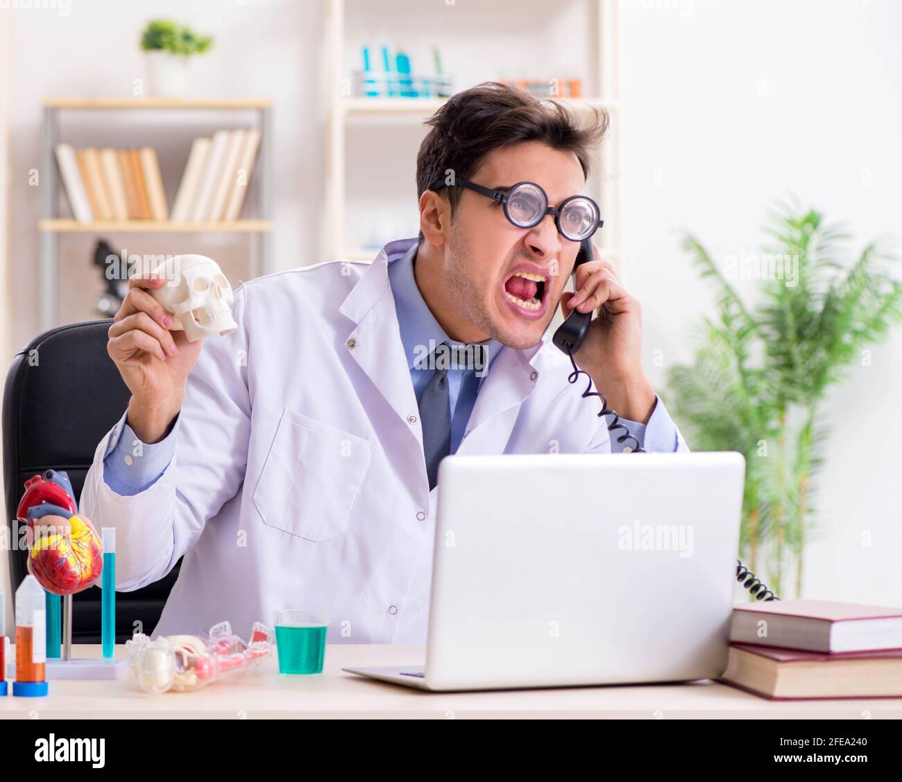 The funny doctor having fun in hospital lab Stock Photo - Alamy