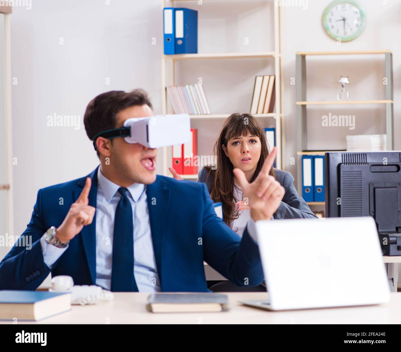 The employee with virtual reality glasses in office Stock Photo - Alamy