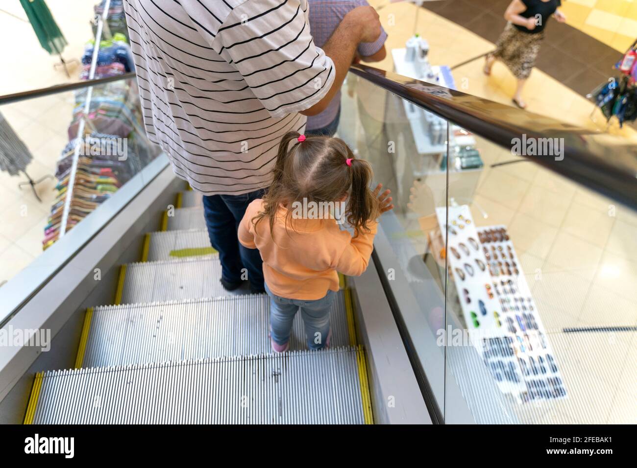 dad and little daughter on the escalator in the mall Stock Photo - Alamy