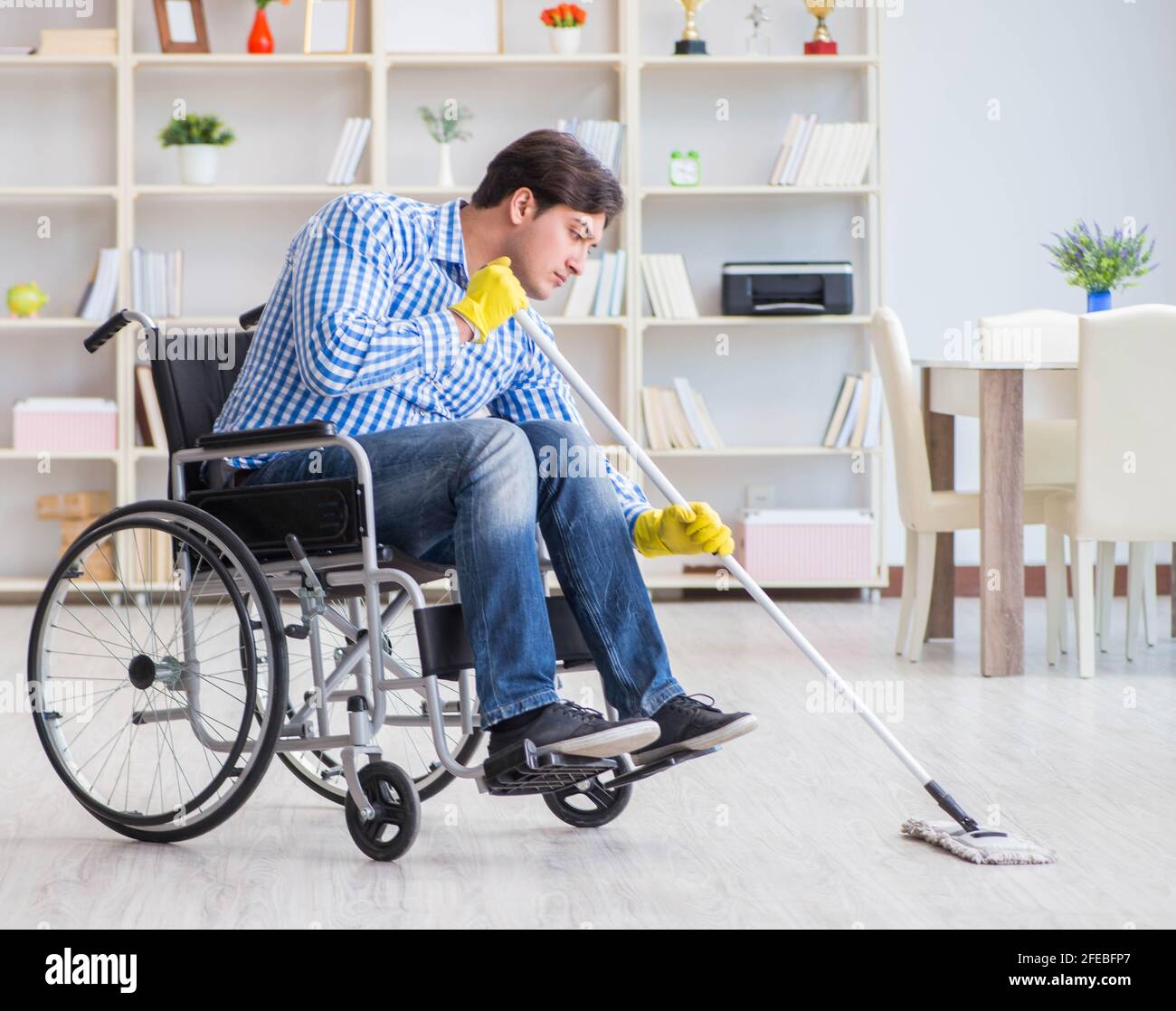 The disabled man on wheelchair cleaning home Stock Photo - Alamy