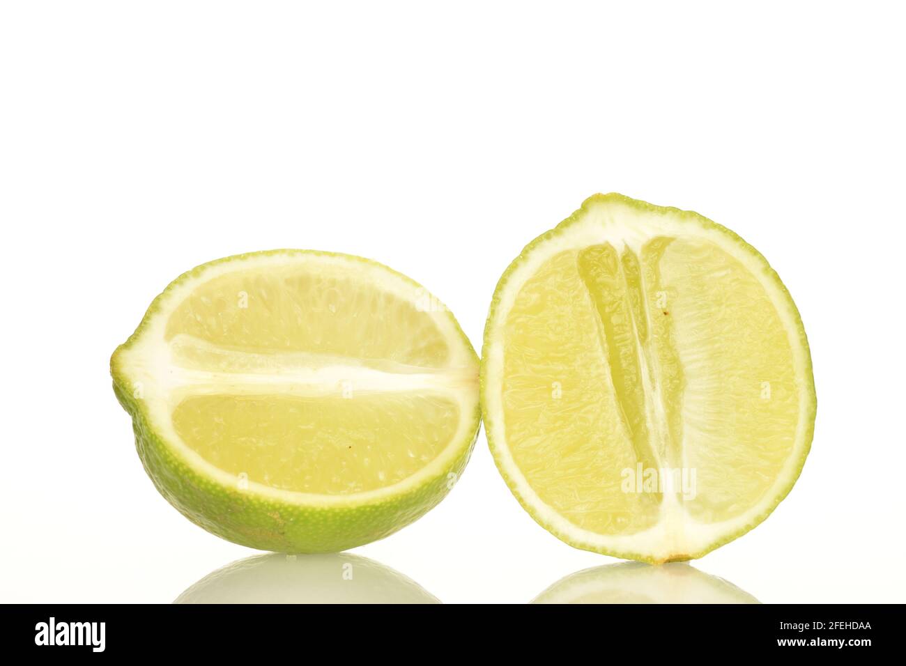 Two ripe halves of lime, close-up, on a white background Stock Photo ...