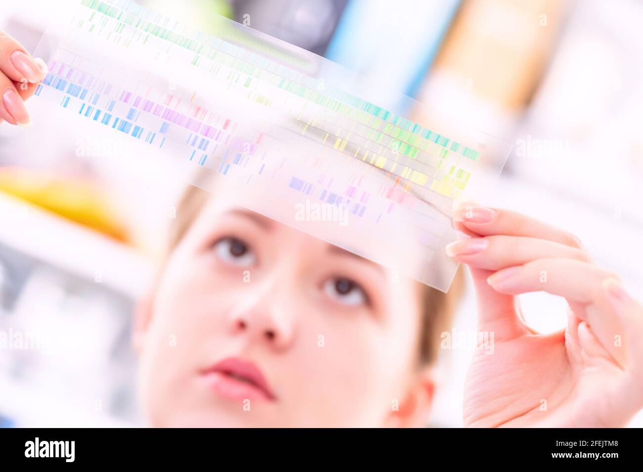 Young woman examines a spectroscopy picture in a quantum physics ...