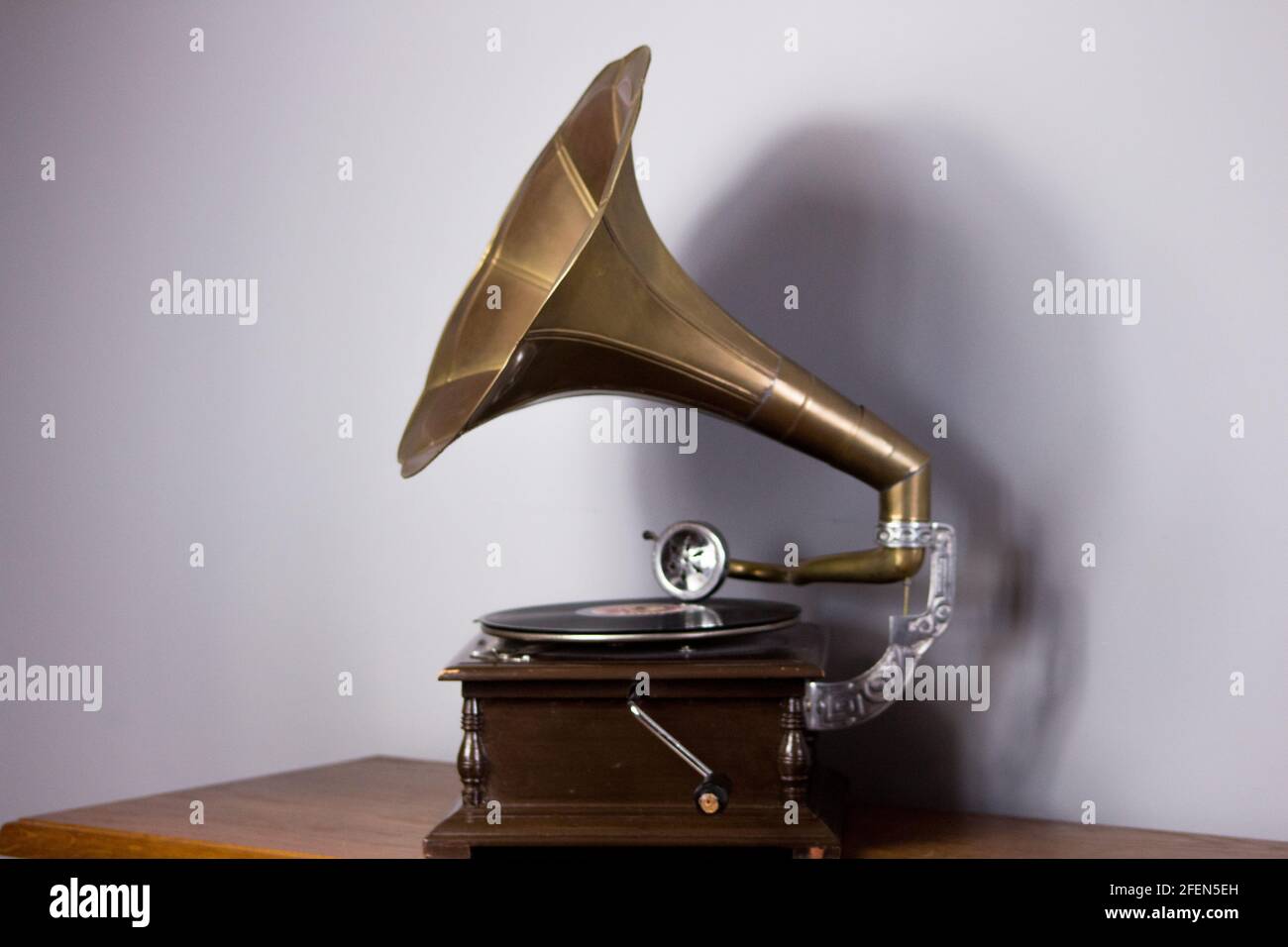 Old gramophone with a plate record. Portable wind-up gramophone ...