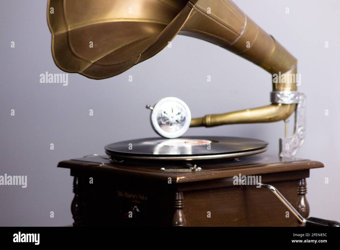 Old gramophone with a plate record. Portable wind-up gramophone ...