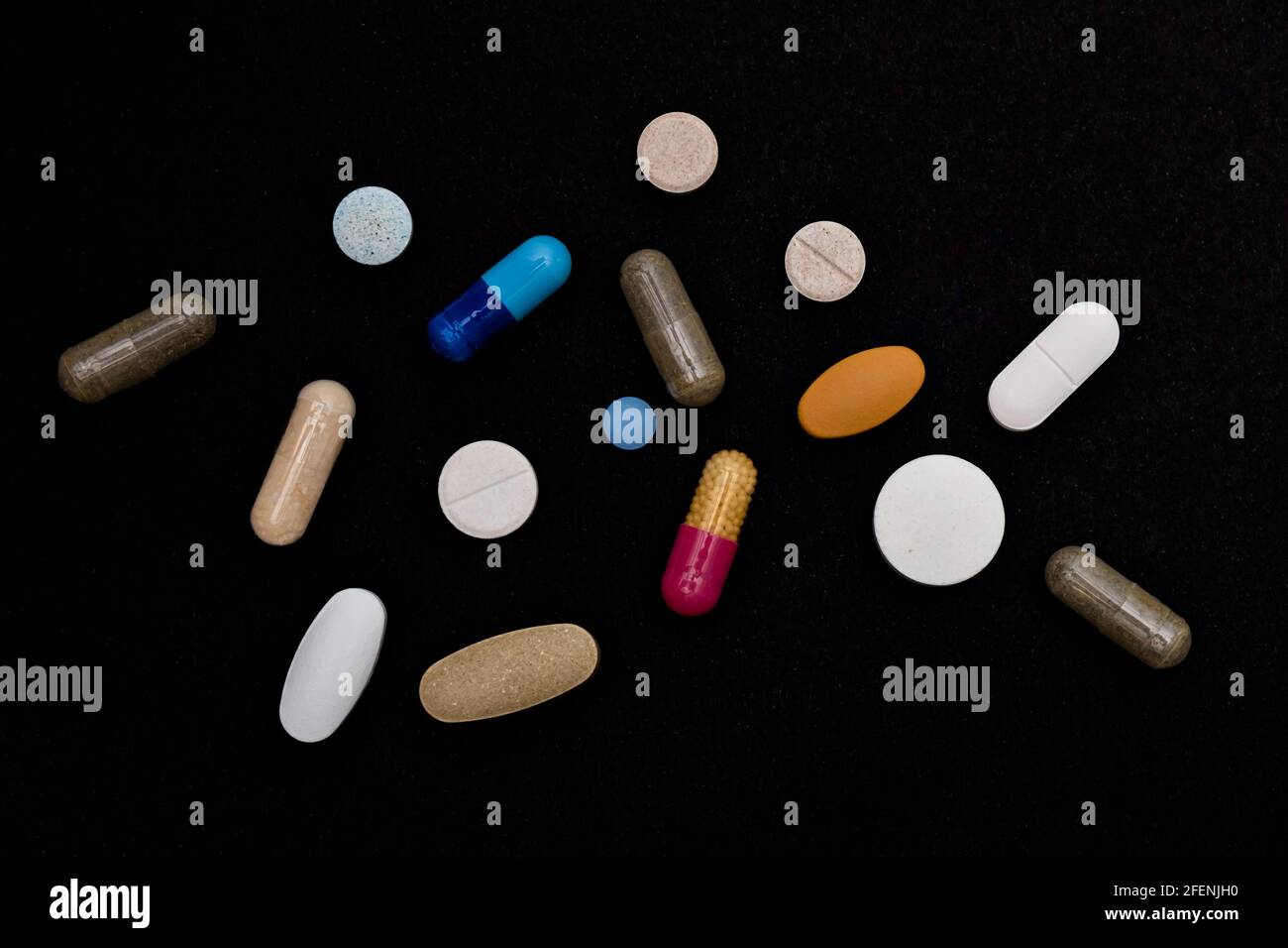 Close-up colorful powder soft capsules pill vitamin blue pink yellow ...