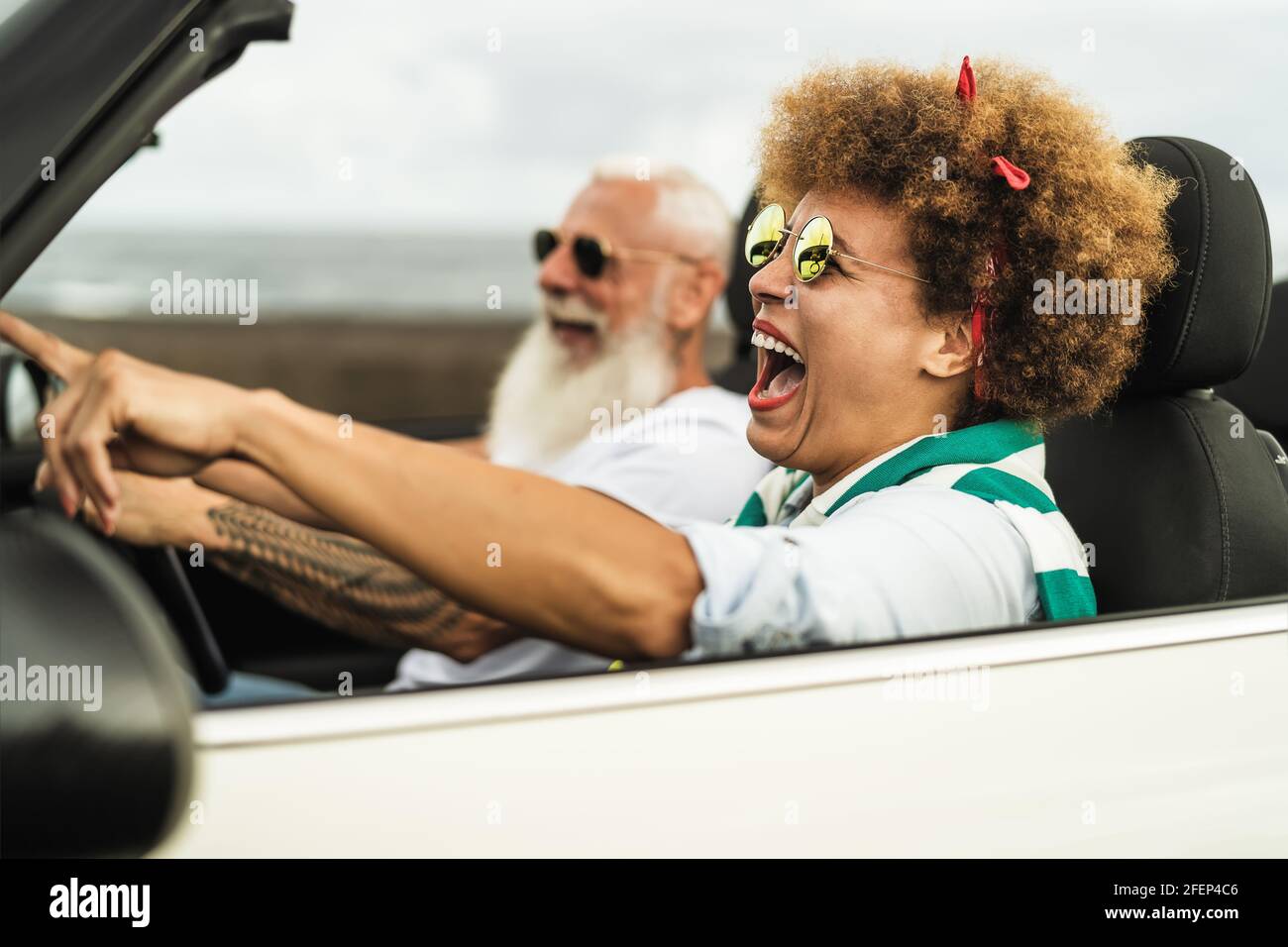 Happy senior couple having fun driving on new convertible car - Mature ...