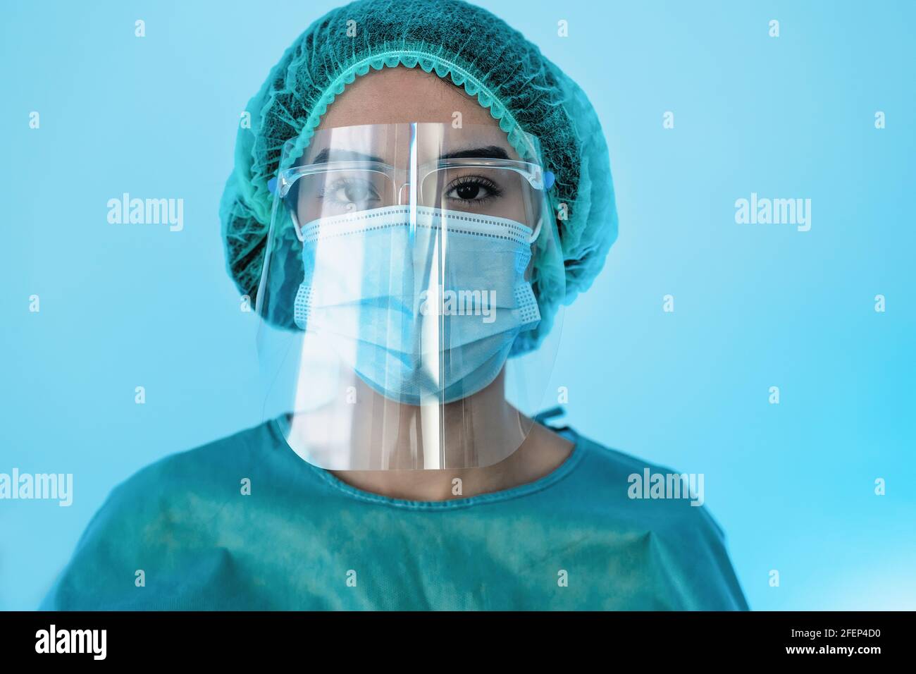 Young female doctor wearing personal protective equipment during corona ...