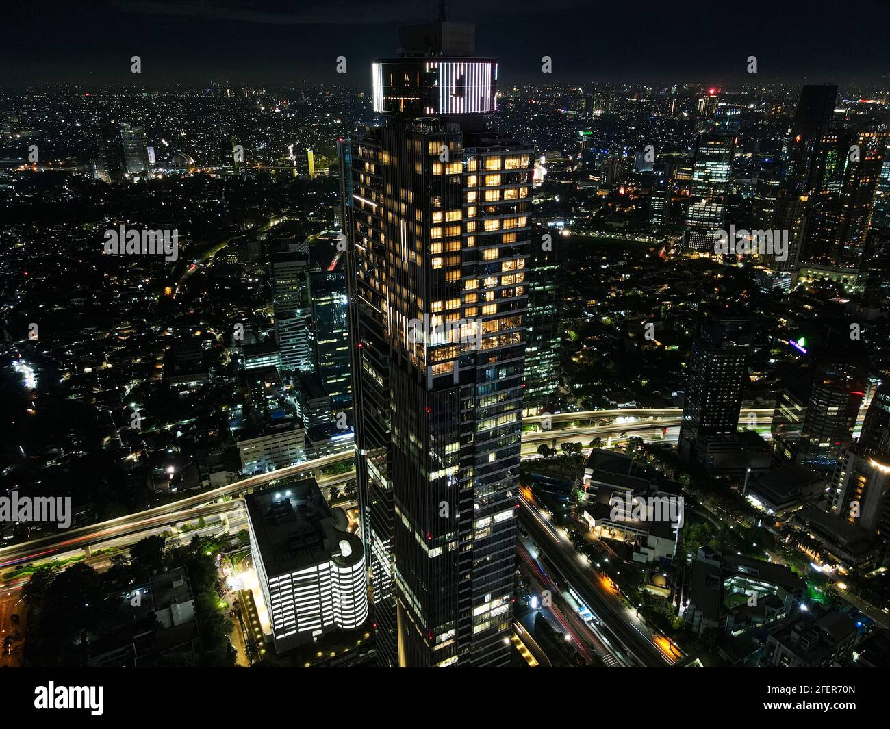 Spectacular nighttime skyline of a big modern city at night. Jakarta ...