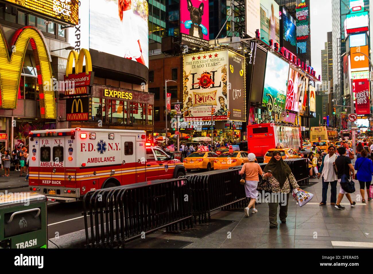 Evening traffic at Times Square with cars and an ambulance Stock Photo ...