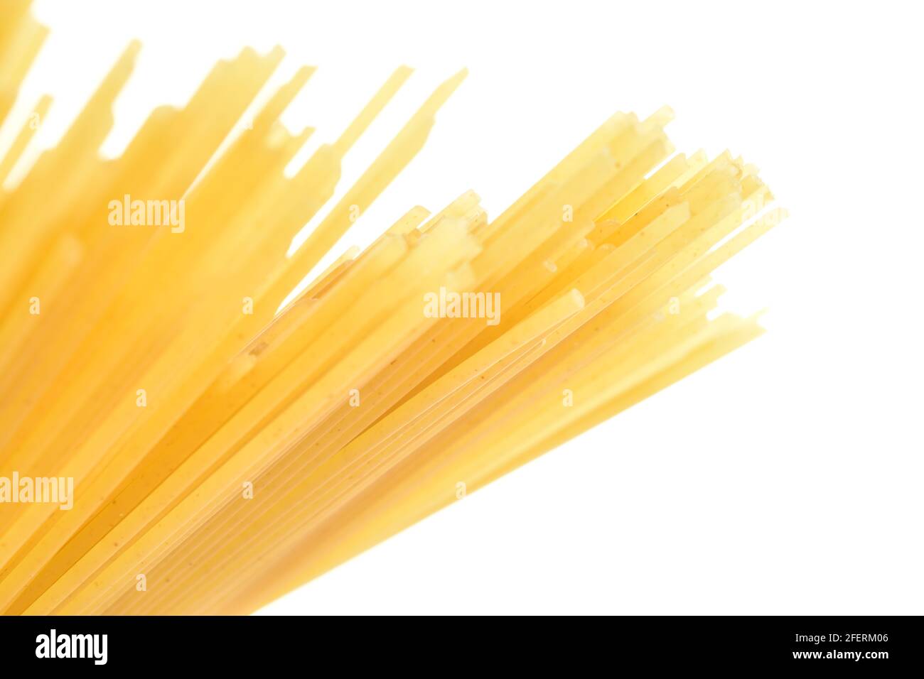 Uncooked bright yellow spaghetti, close-up, isolated on white Stock ...