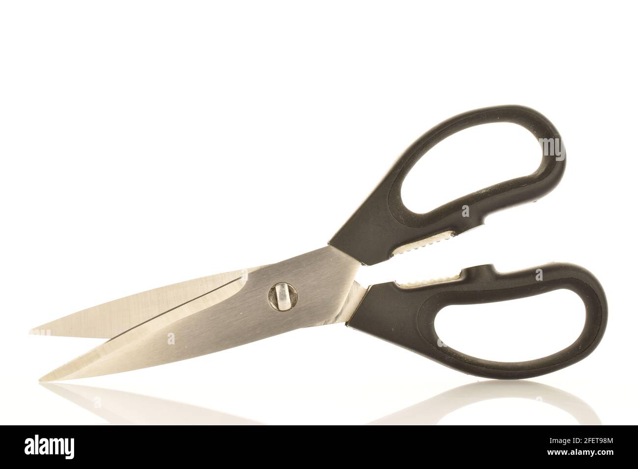 One metal scissors with black plastic handles, for the kitchen, close ...
