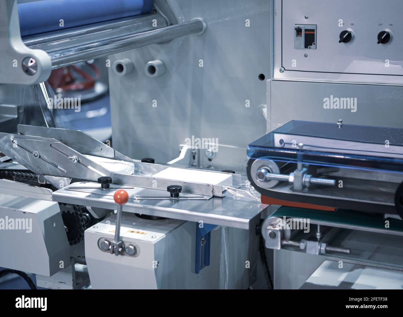 Automatic food package flow wrapping machine. Food packaging machine in ...