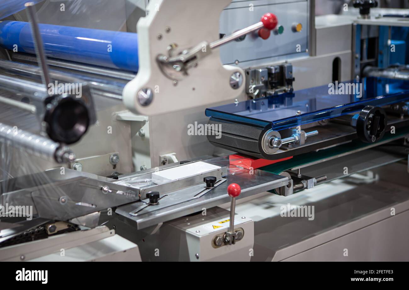 Automatic food package flow wrapping machine. Food packaging machine in ...