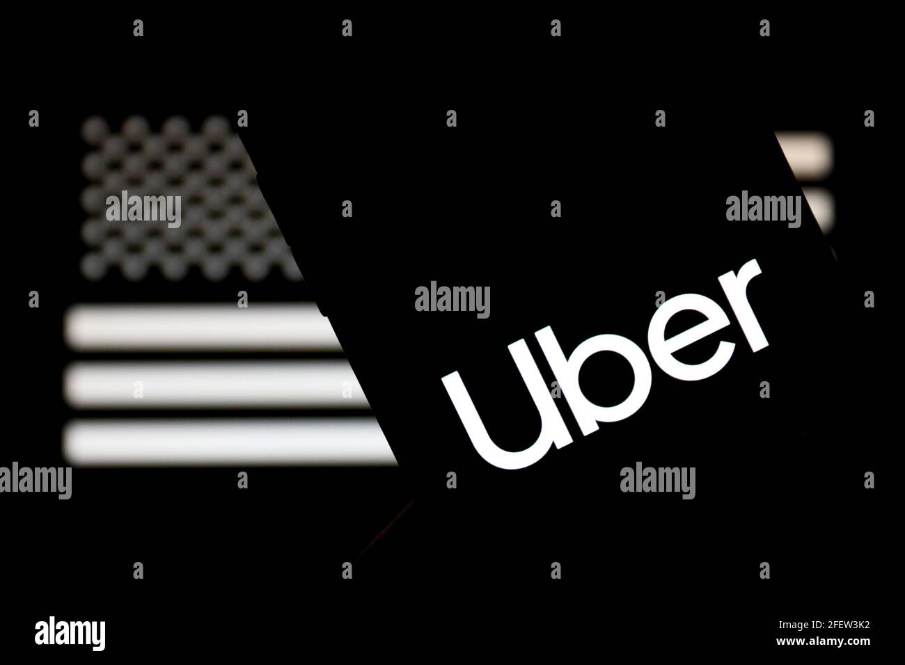 In this photo illustration an Uber company app logo seen displayed on a ...