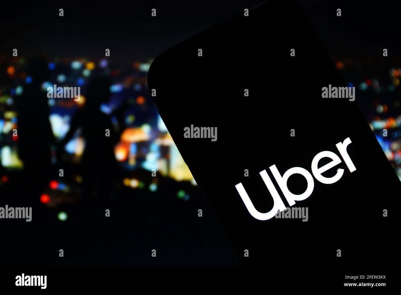 In this photo illustration an Uber company app logo seen displayed on a ...