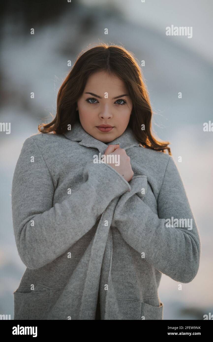 Vertical shot of a Bosnian beautiful woman with blonde hair and a coat ...