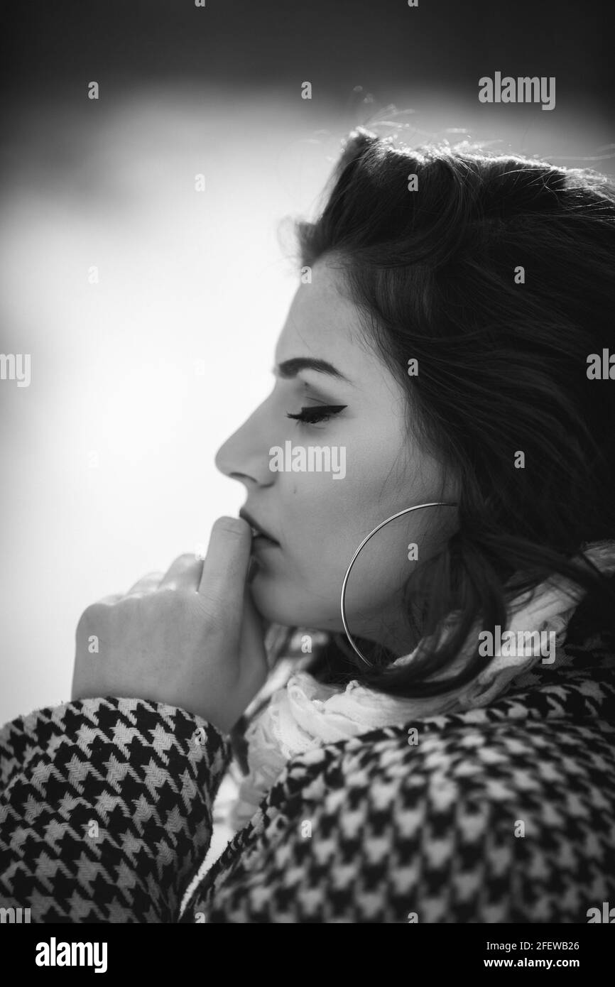Grayscale shot of a Bosnian beautiful woman with a thoughtful face ...