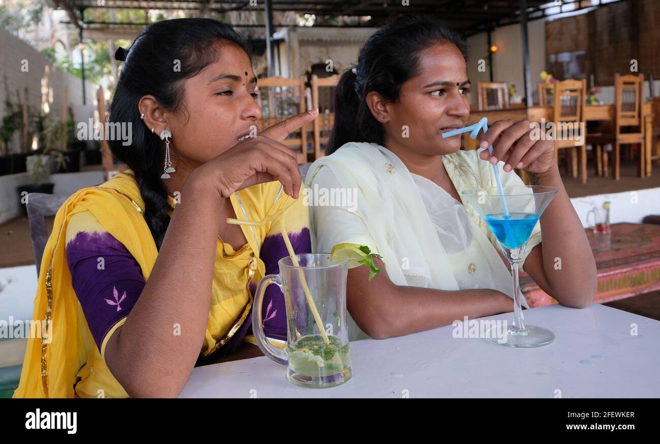 Young Indian female friends enjoying their time in a cafe Stock Photo ...