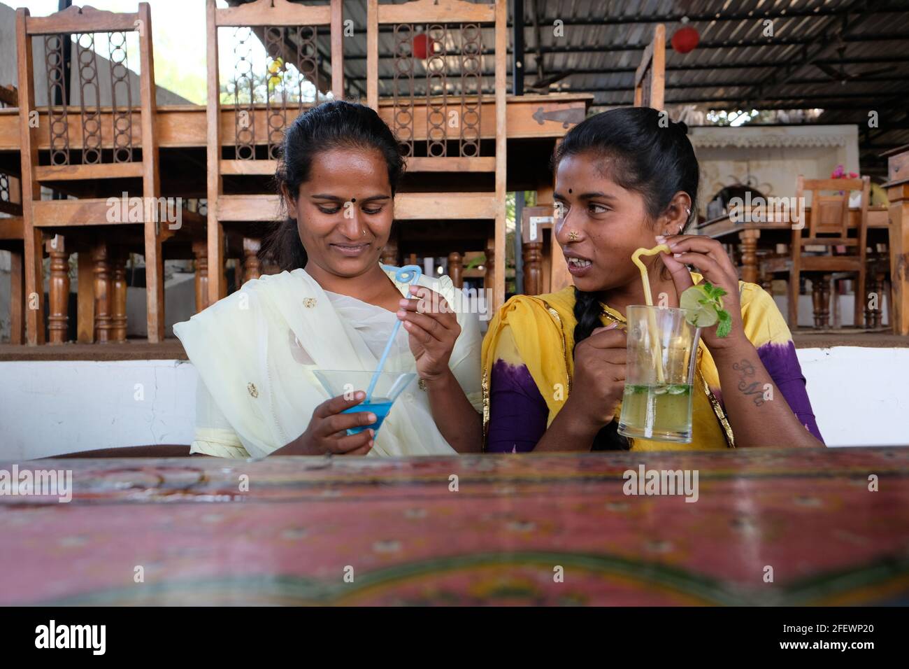 Young Indian female friends enjoying their time in a cafe Stock Photo ...