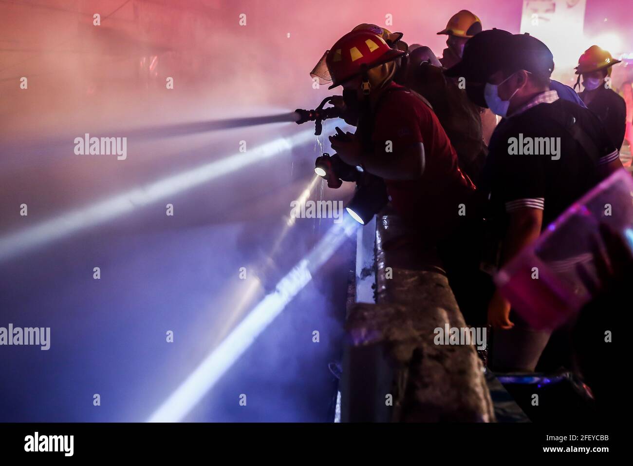 Quezon City, Philippines. 24th Apr, 2021. Firefighters try to put out a ...