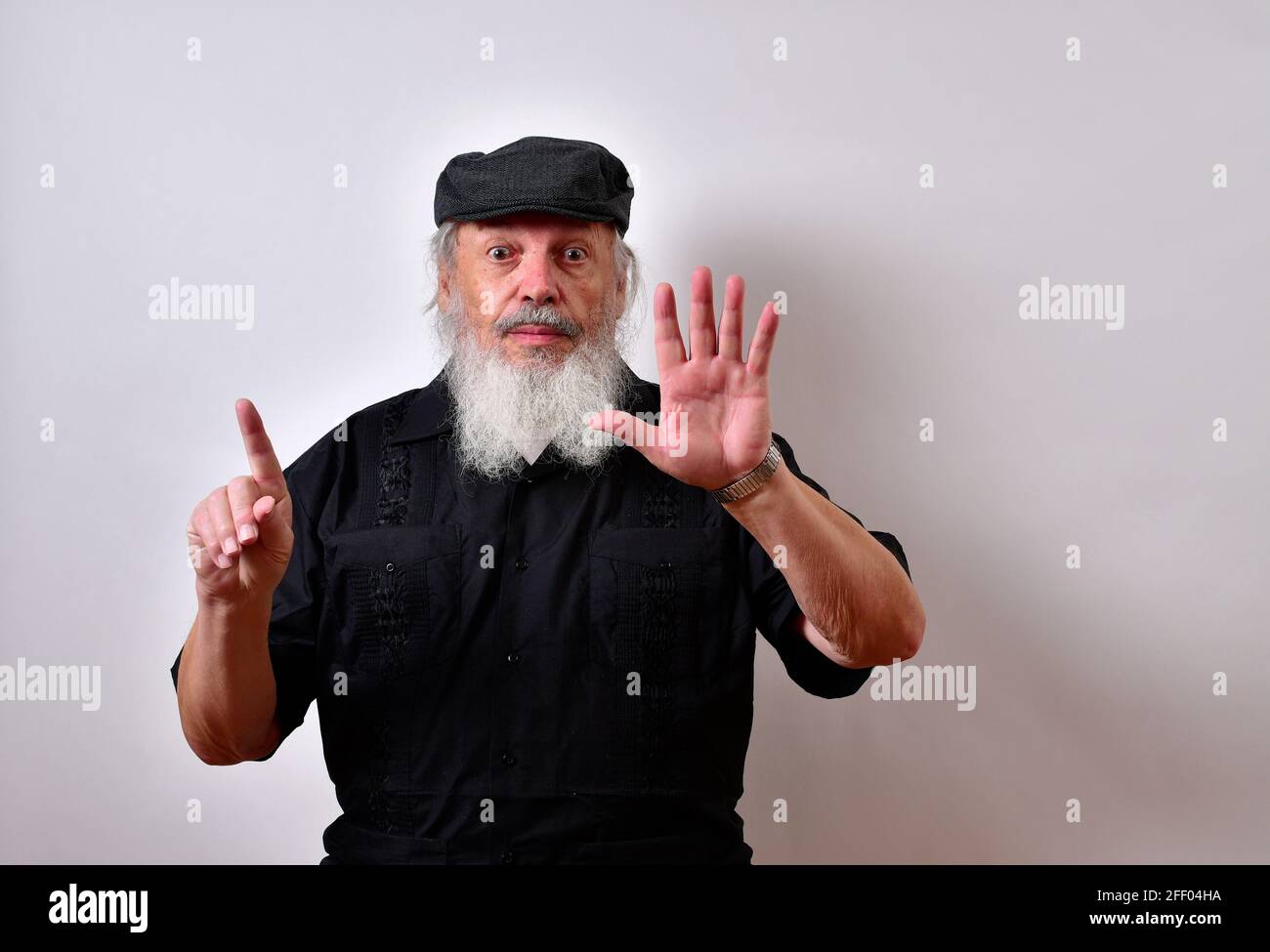 View of an Old man holds up five fingers on one hand and one finger on ...