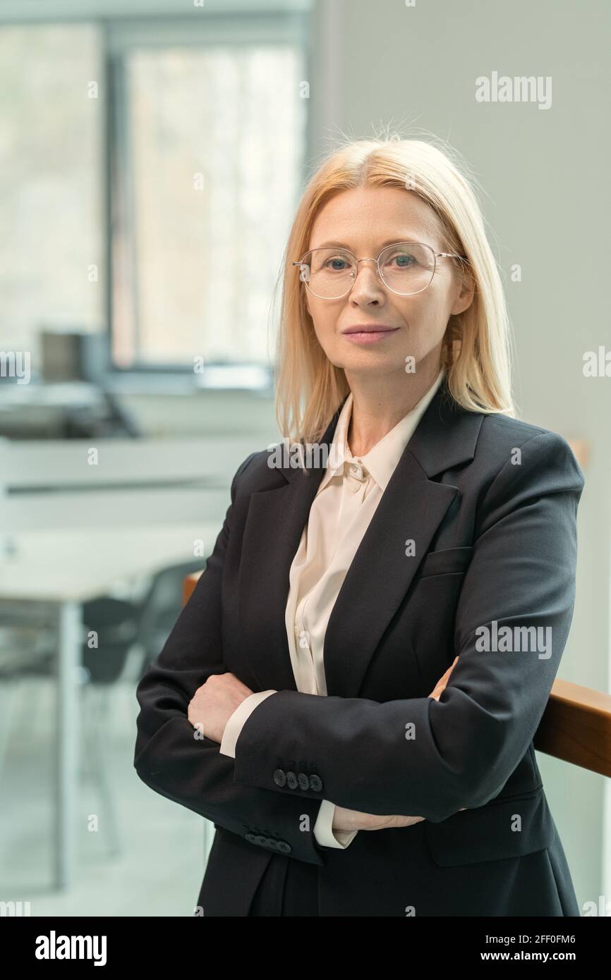 Portrait of content confident female business executive in black jacket ...