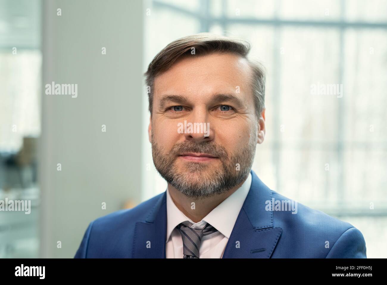 Portrait Of Smiling Handsome Middle Aged Businessman With Stubble