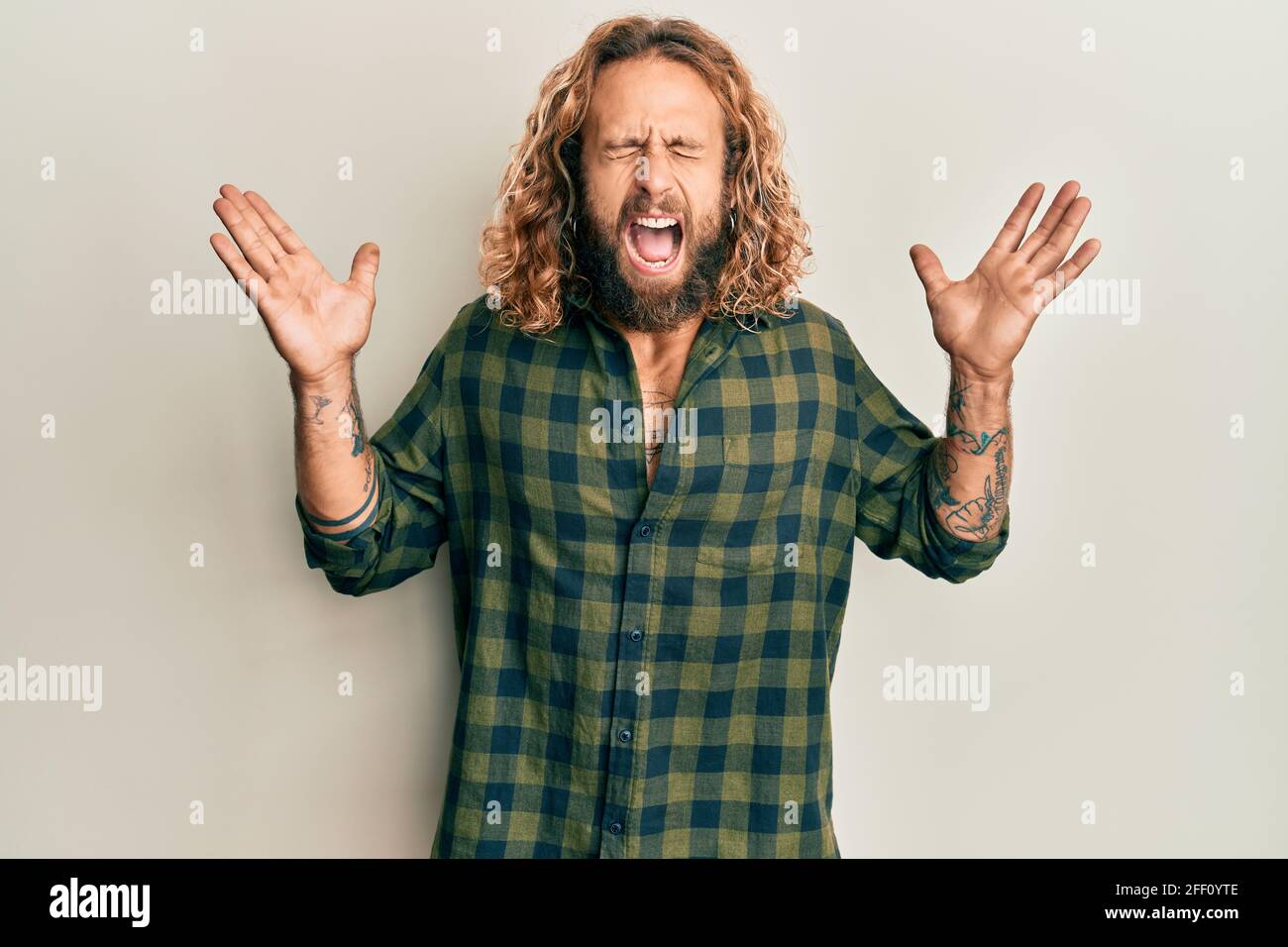 Handsome man with beard and long hair wearing casual clothes ...