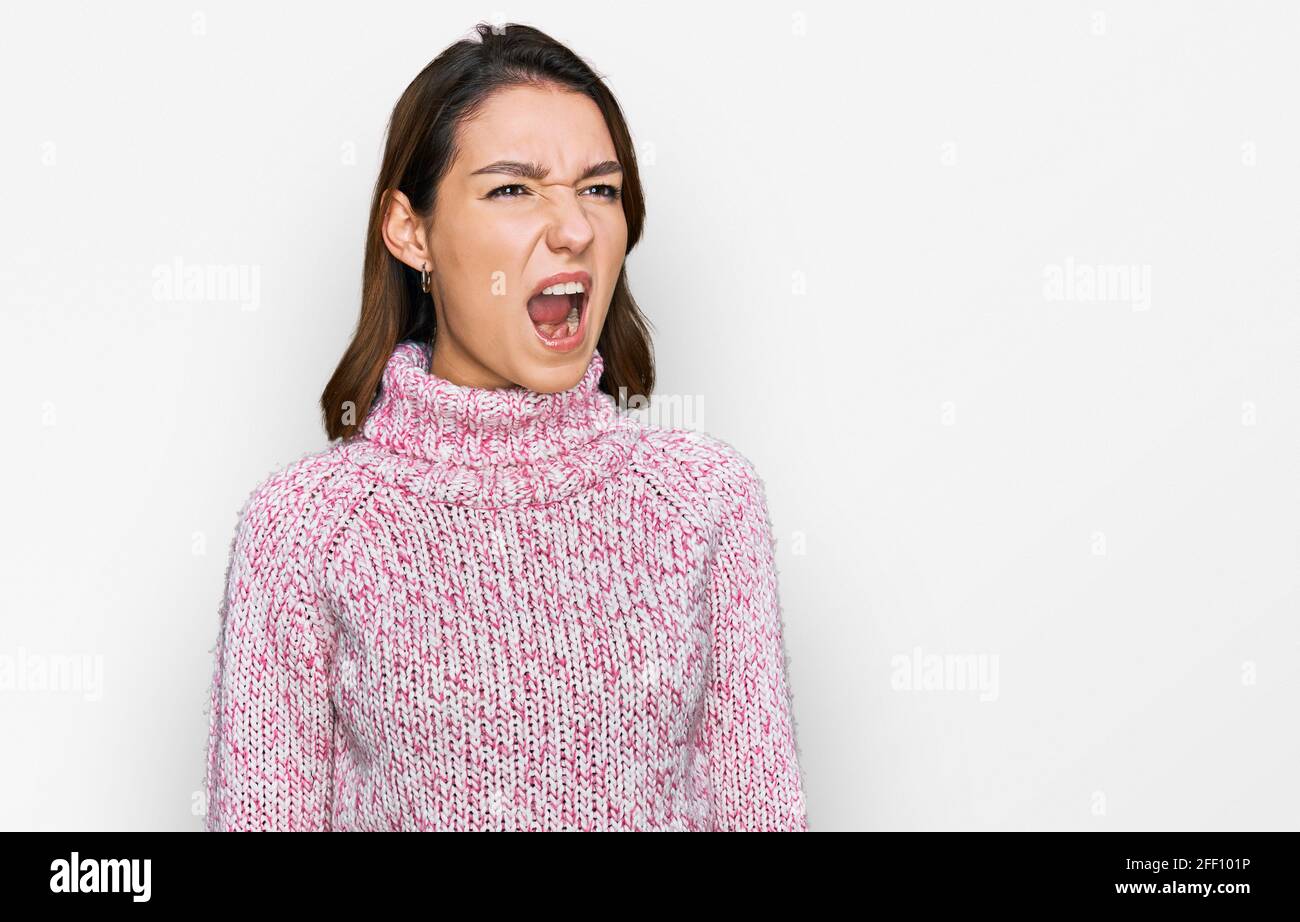 Young caucasian girl wearing wool winter sweater angry and mad ...