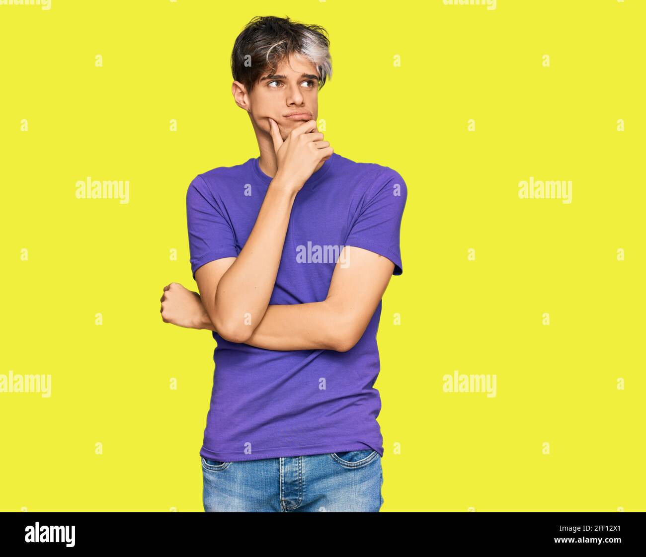 Young hispanic man wearing casual clothes serious face thinking about ...