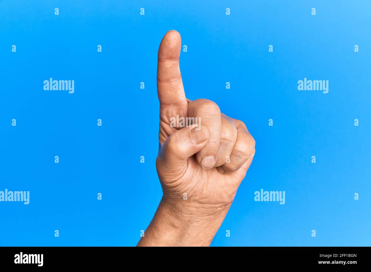 Hand of senior hispanic man over blue isolated background counting ...