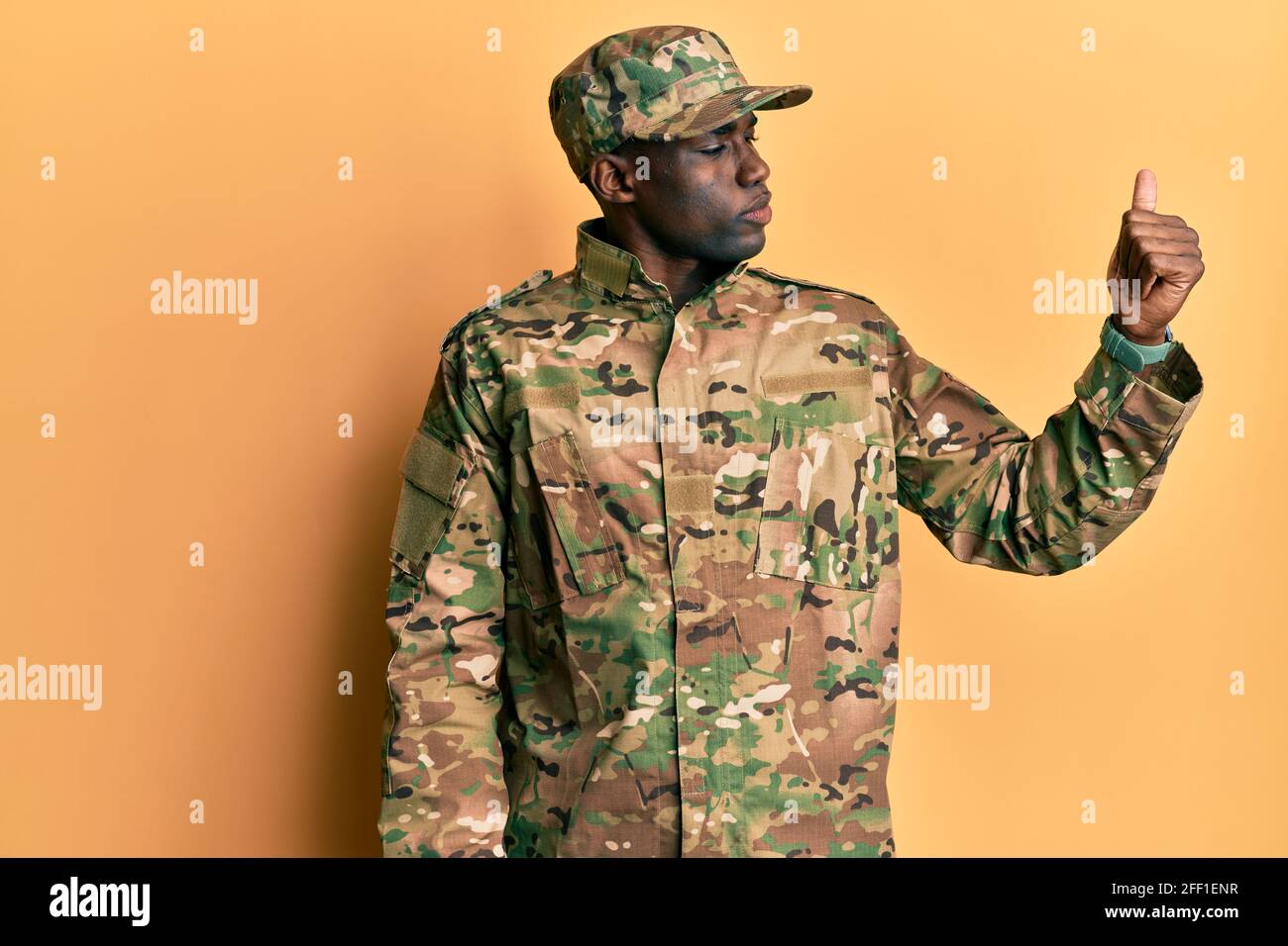 Young african american man wearing army uniform looking proud, smiling ...