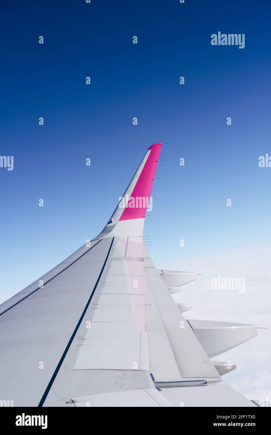 Blank wing of a flying plane against the bright blue sky Stock Photo ...