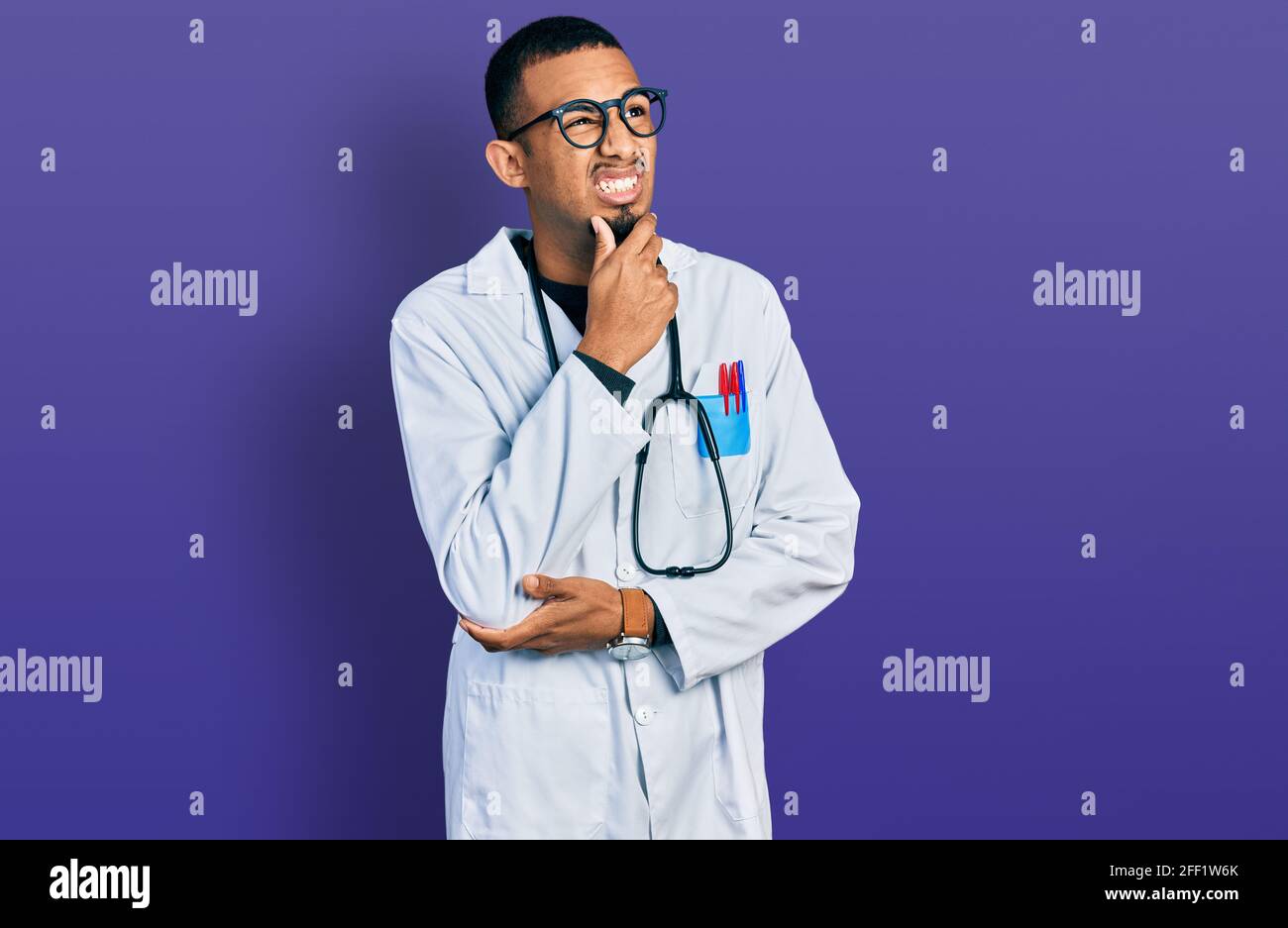 Young african american man wearing doctor uniform and stethoscope ...